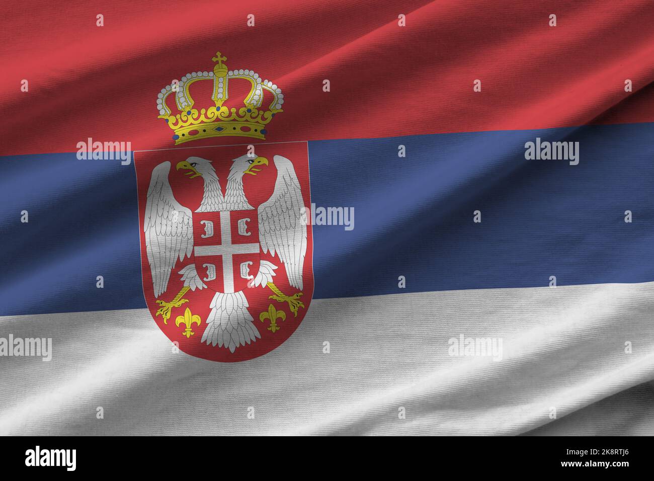 Serbia flag with big folds waving close up under the studio light ...