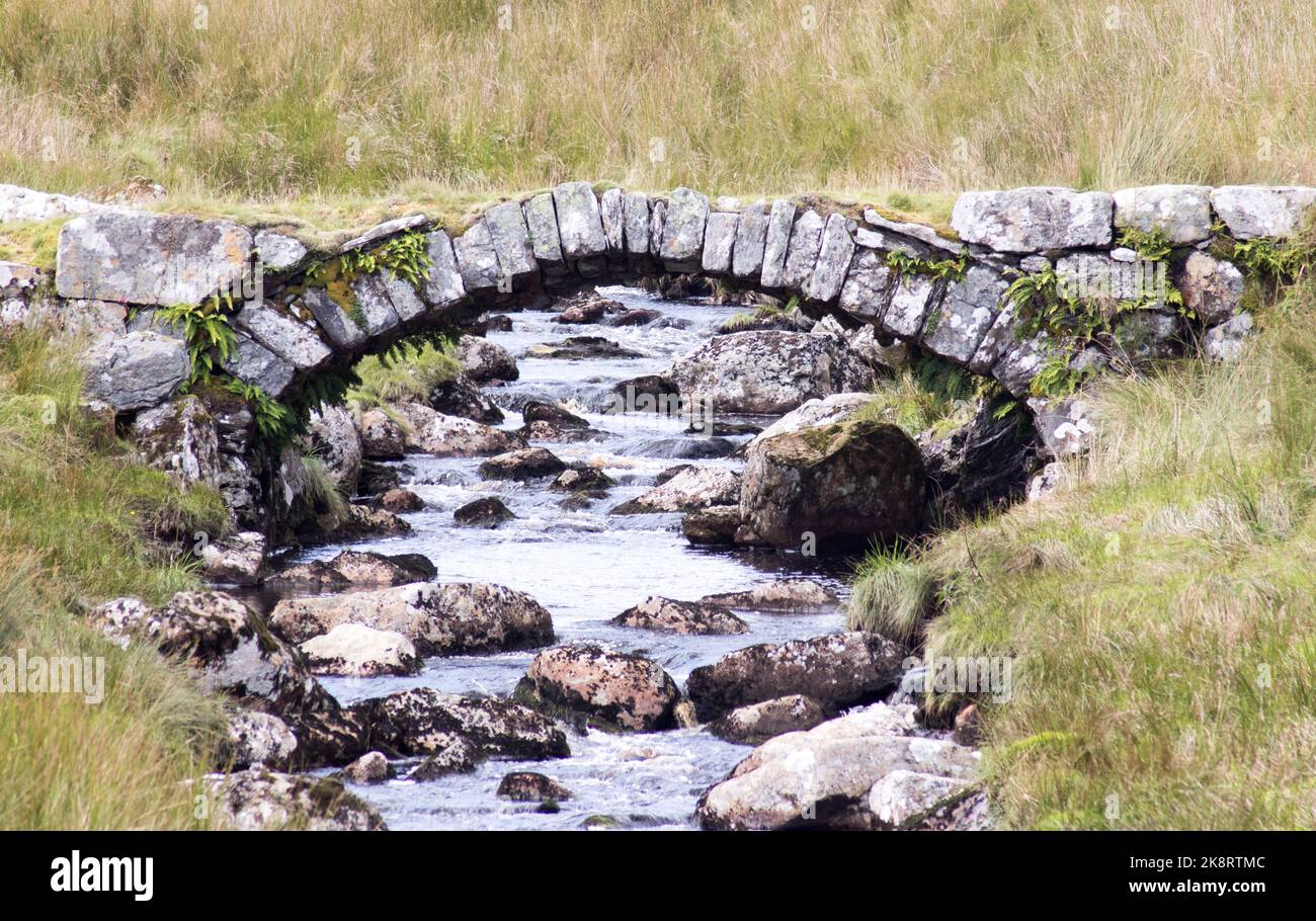 A river flowing under a small stone bridge Stock Photo - Alamy