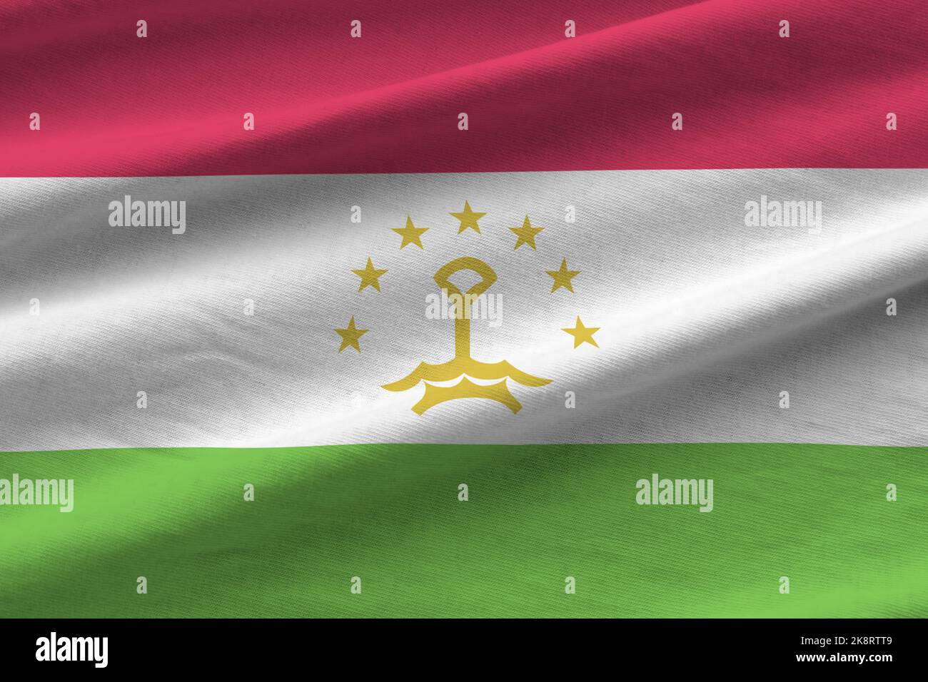 Tajikistan flag with big folds waving close up under the studio light ...