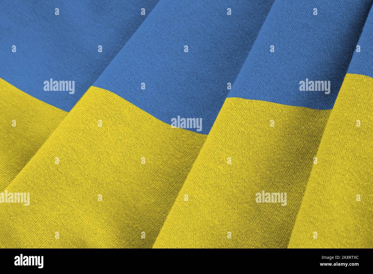 Ukraine flag with big folds waving close up under the studio light ...