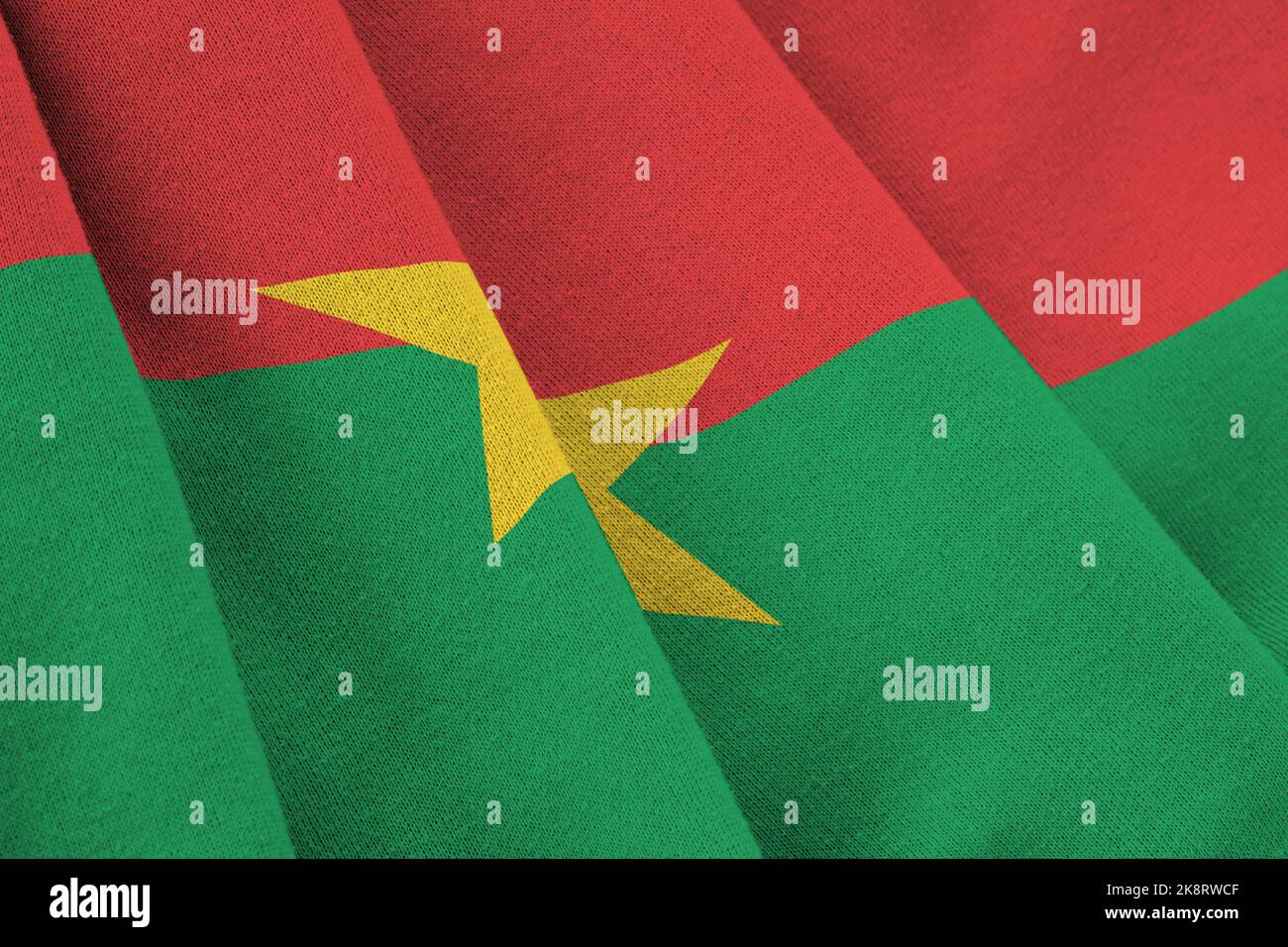 Burkina Faso flag with big folds waving close up under the studio light ...