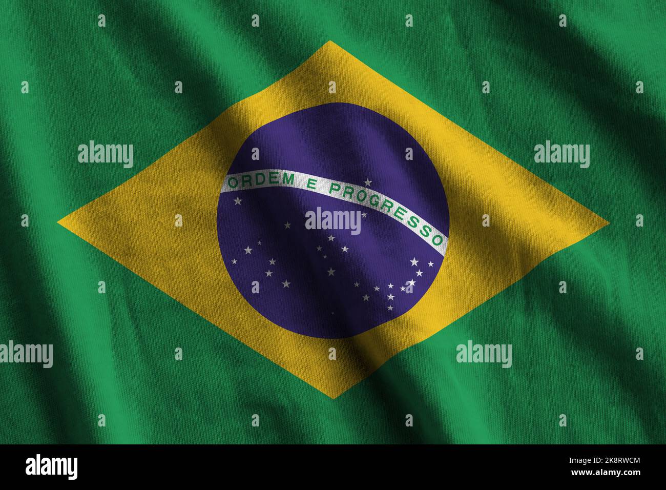 Brazil flag with big folds waving close up under the studio light ...