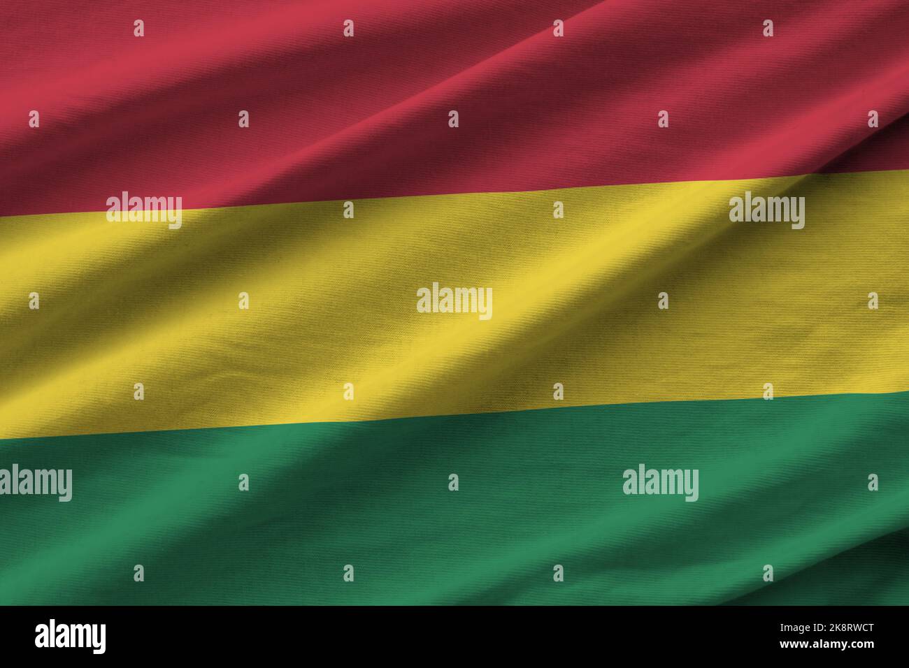 Bolivia flag with big folds waving close up under the studio light ...