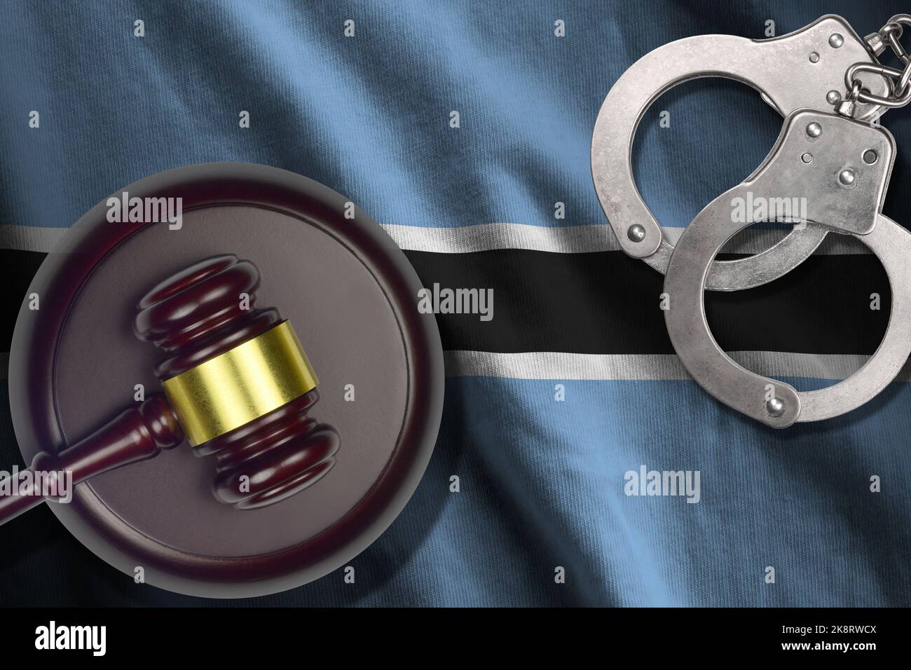 Botswana flag with judge mallet and handcuffs in dark room. Concept of ...