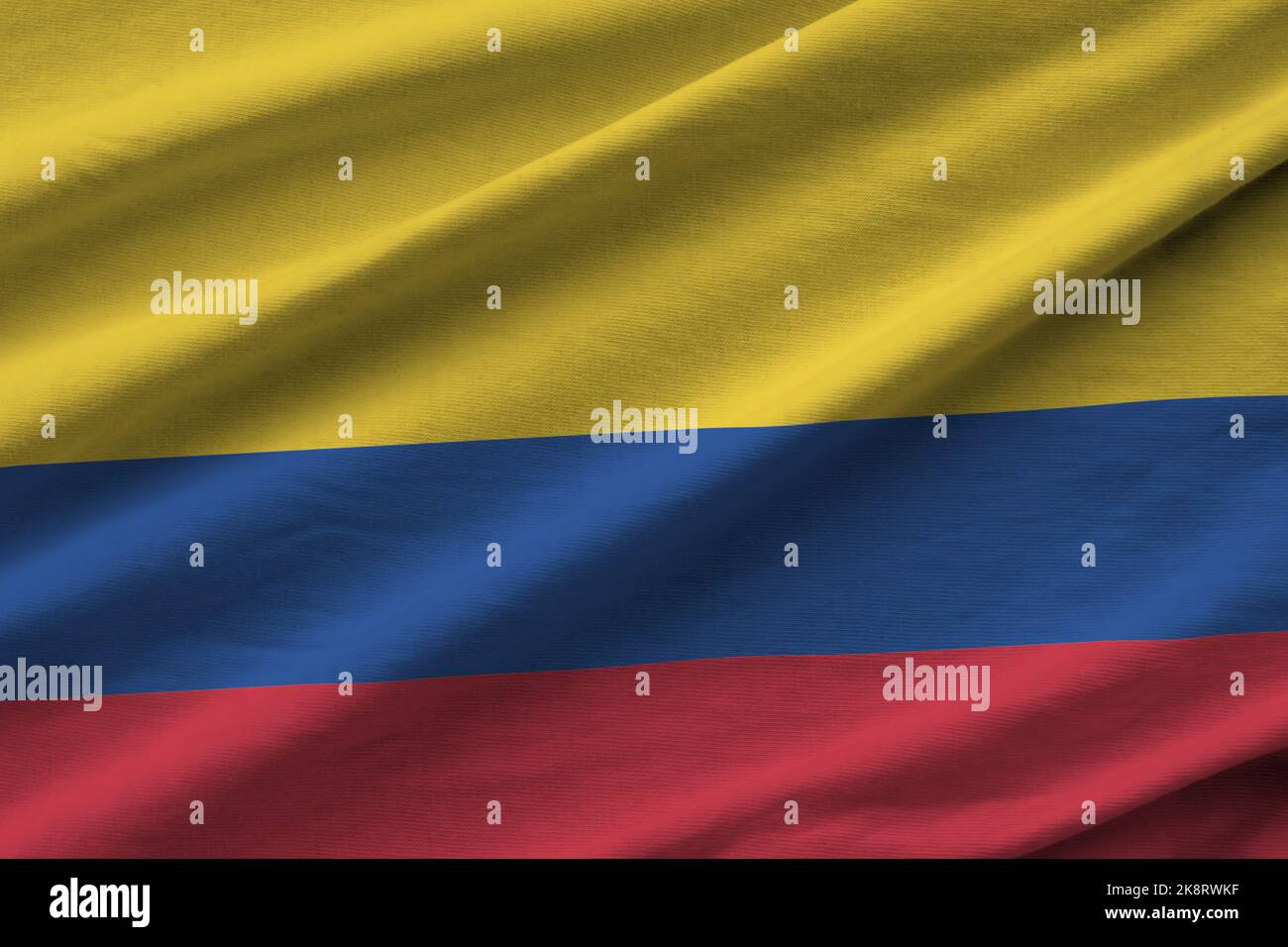 Colombia flag with big folds waving close up under the studio light ...