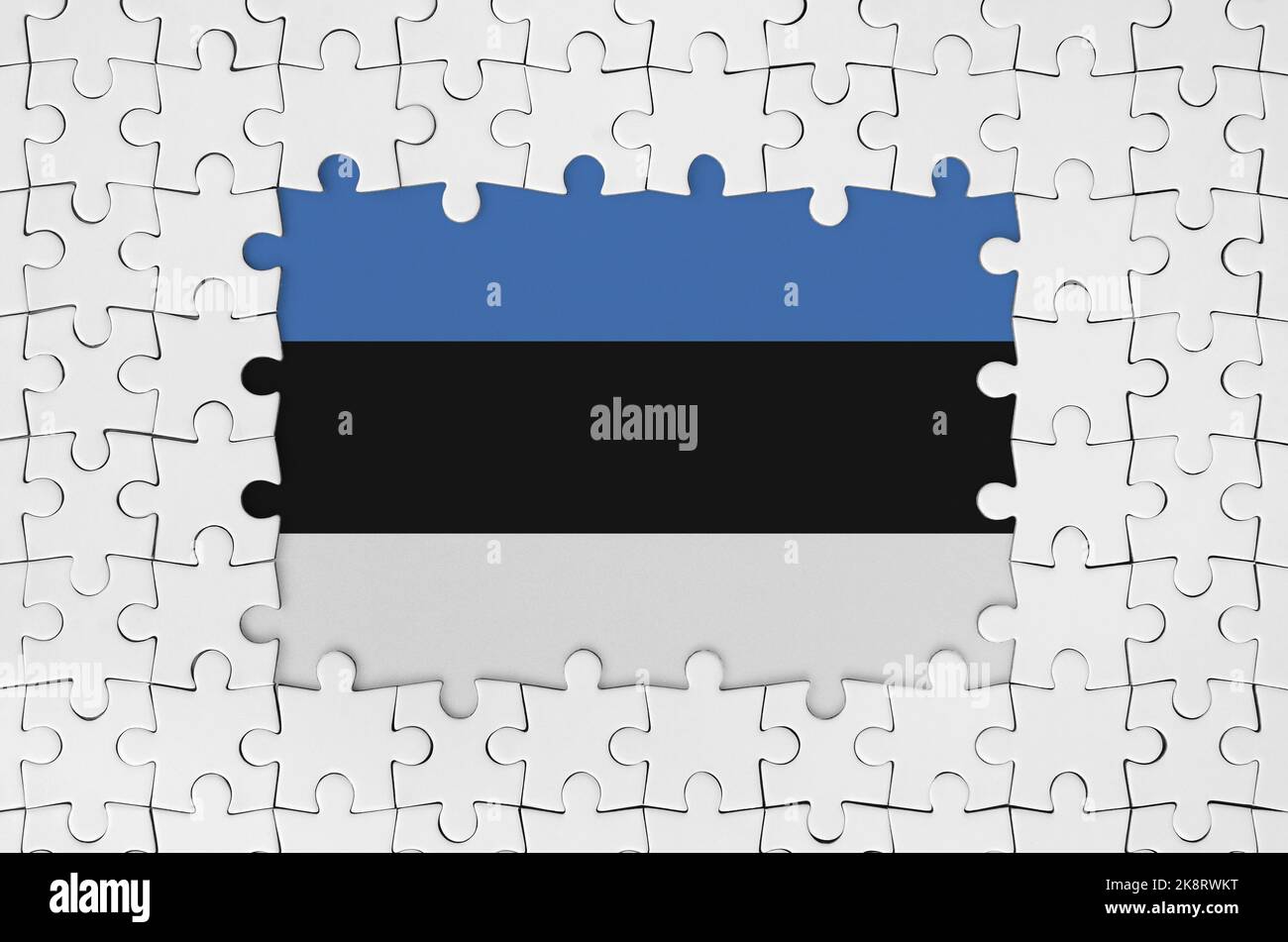 Estonia flag in frame of white puzzle pieces with missing central parts ...