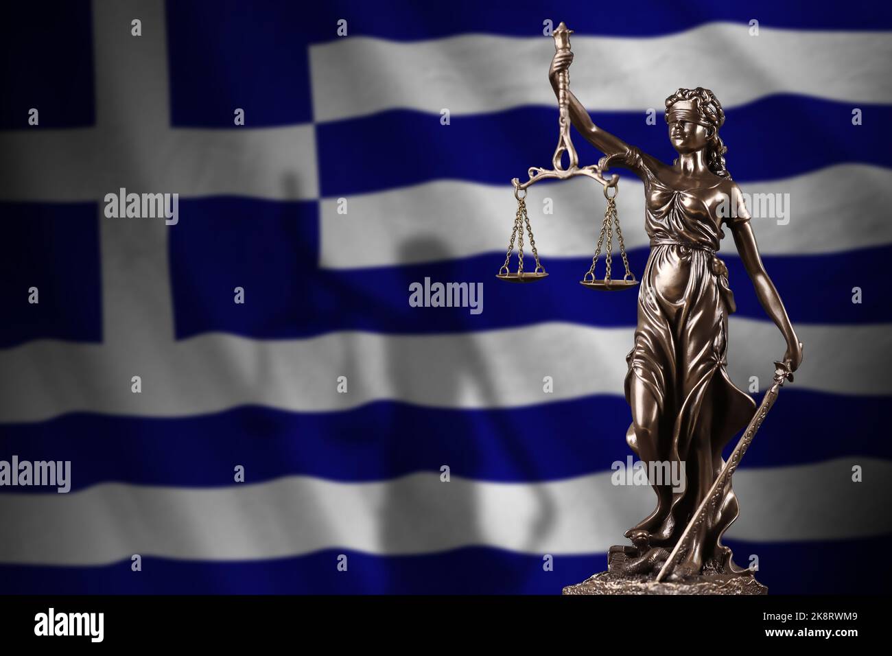 Greece flag with statue of lady justice and judicial scales in dark ...