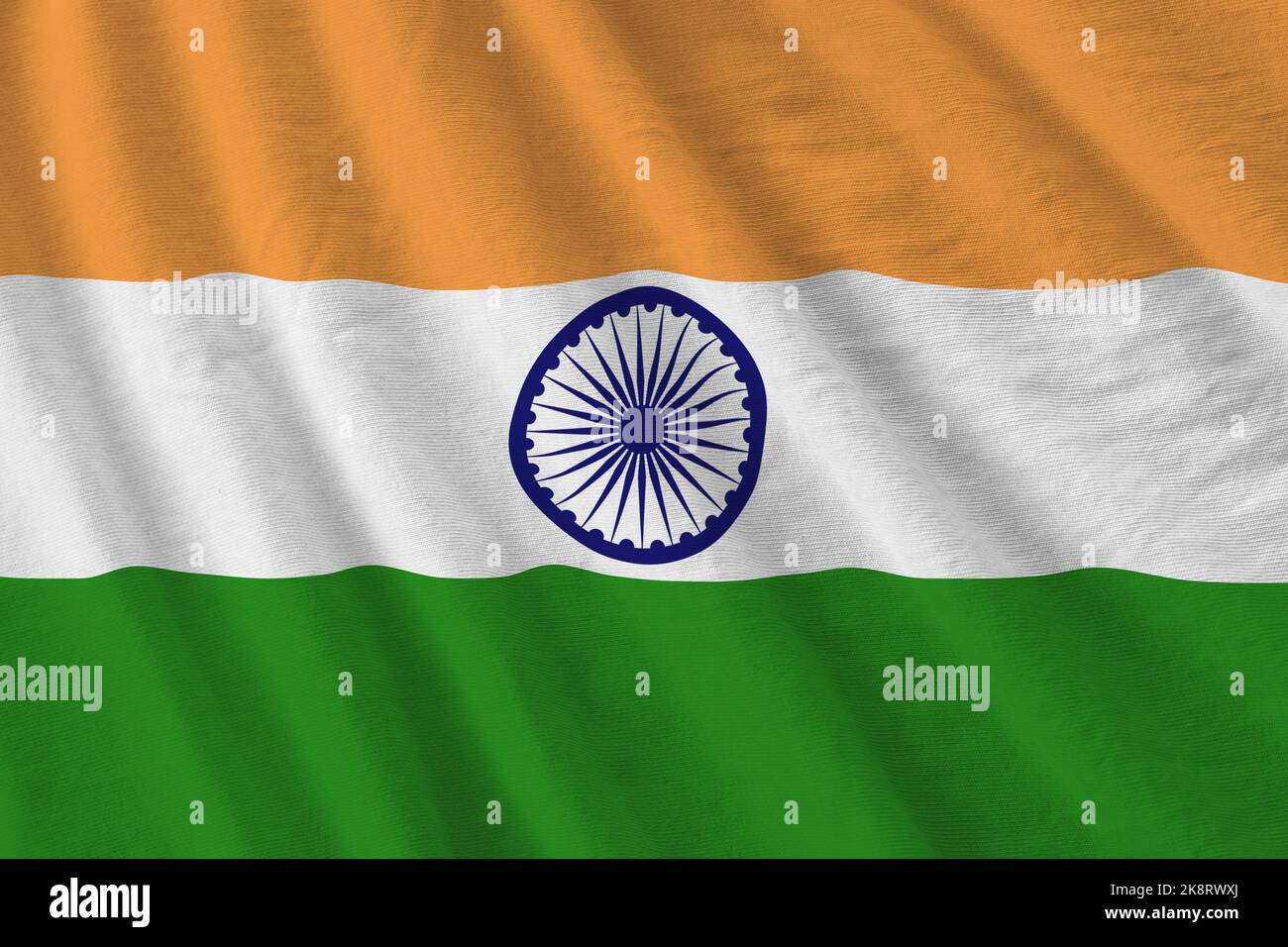 India flag with big folds waving close up under the studio light ...