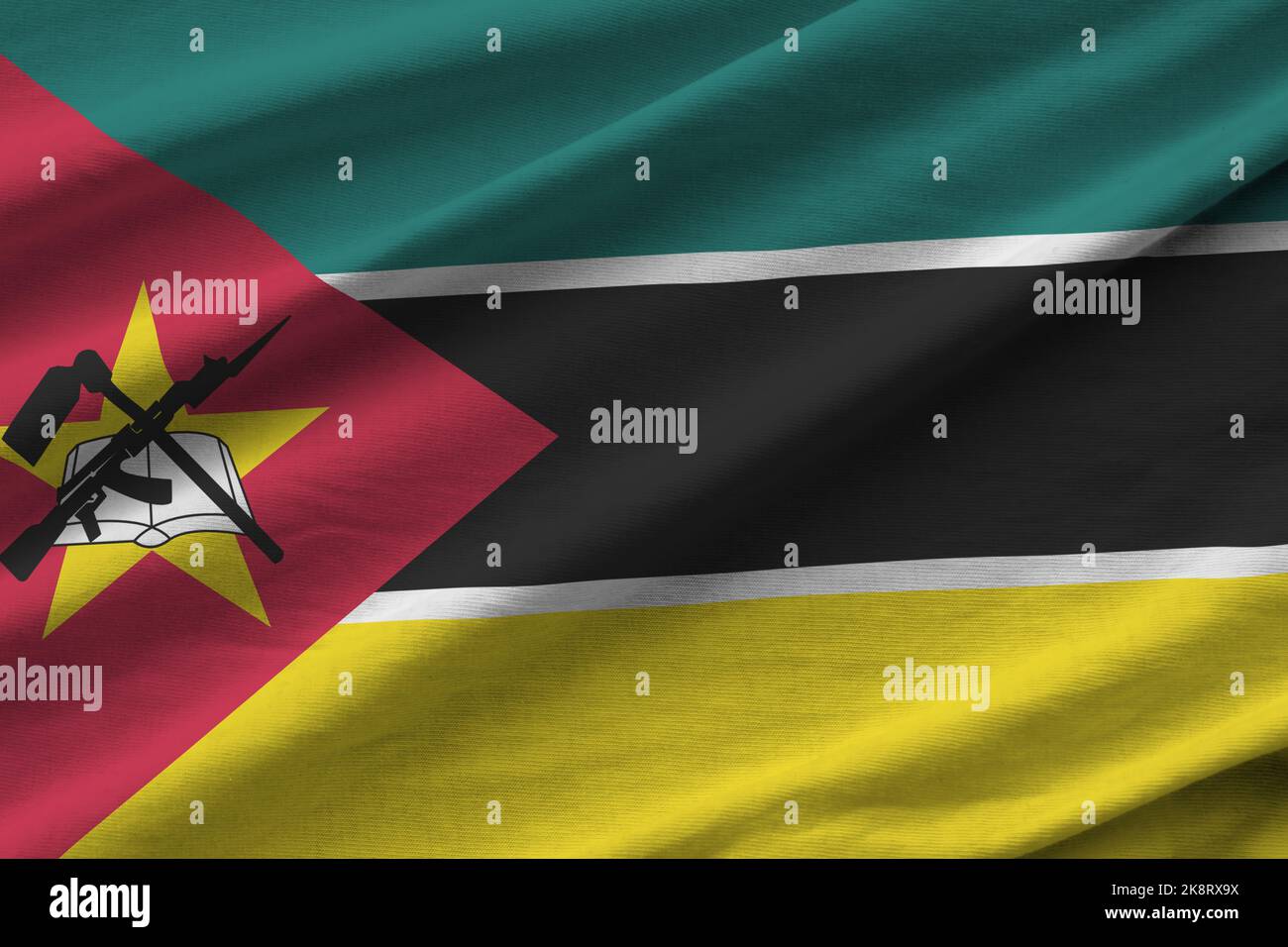 Mozambique flag with big folds waving close up under the studio light ...