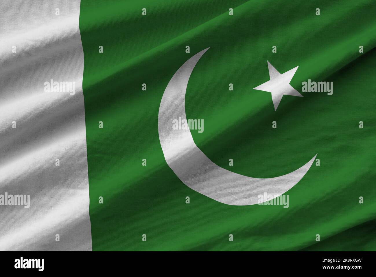 Pakistan flag with big folds waving close up under the studio light ...