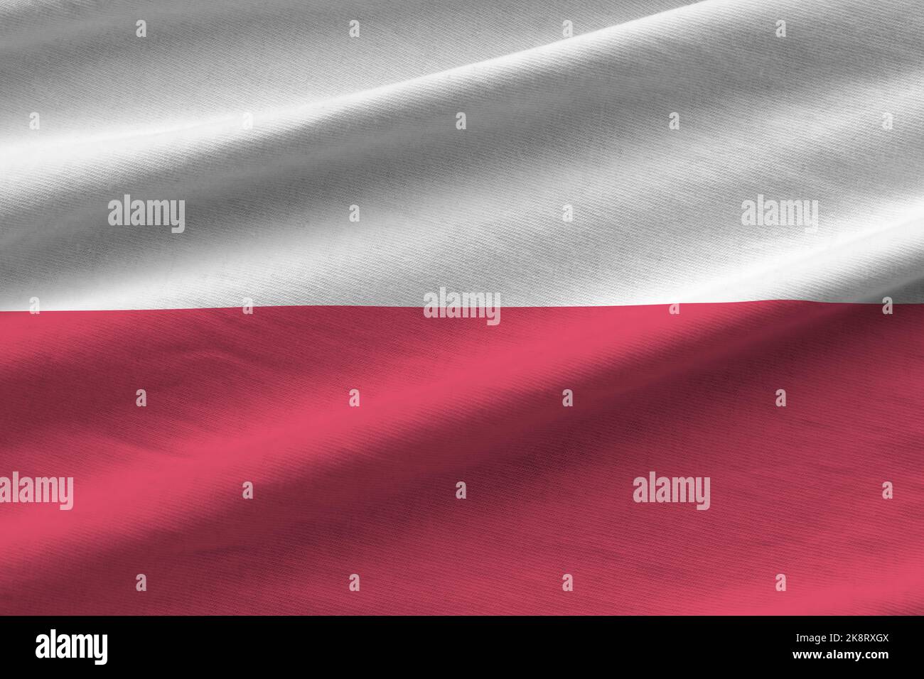 Poland flag with big folds waving close up under the studio light ...