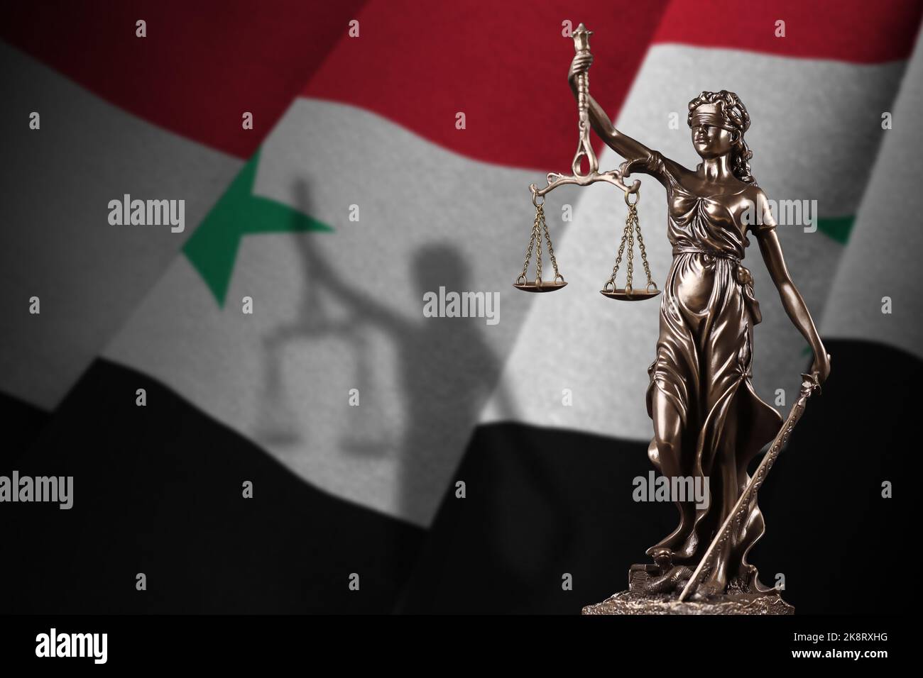Syria flag with statue of lady justice and judicial scales in dark room ...