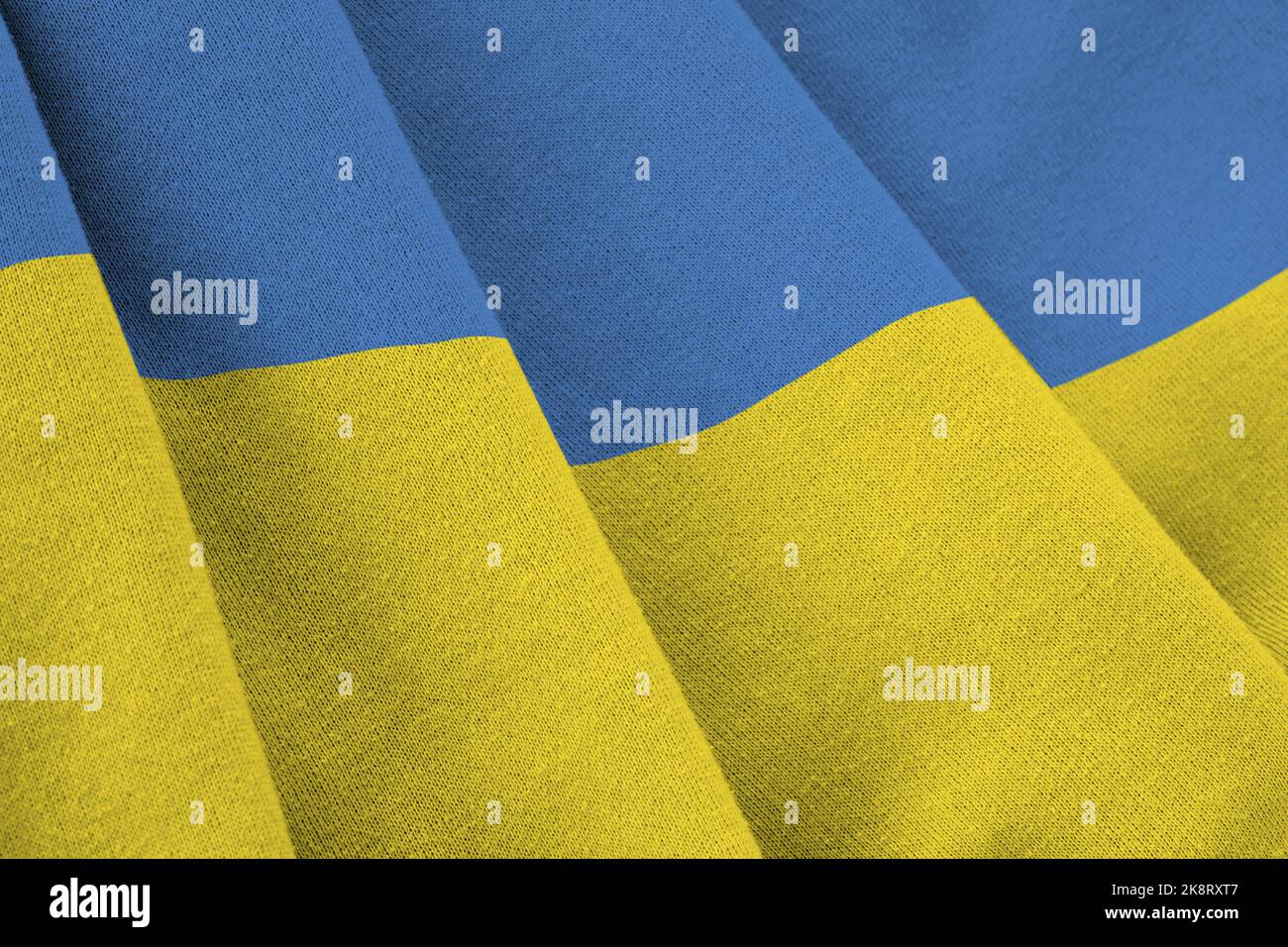 Ukraine flag with big folds waving close up under the studio light ...
