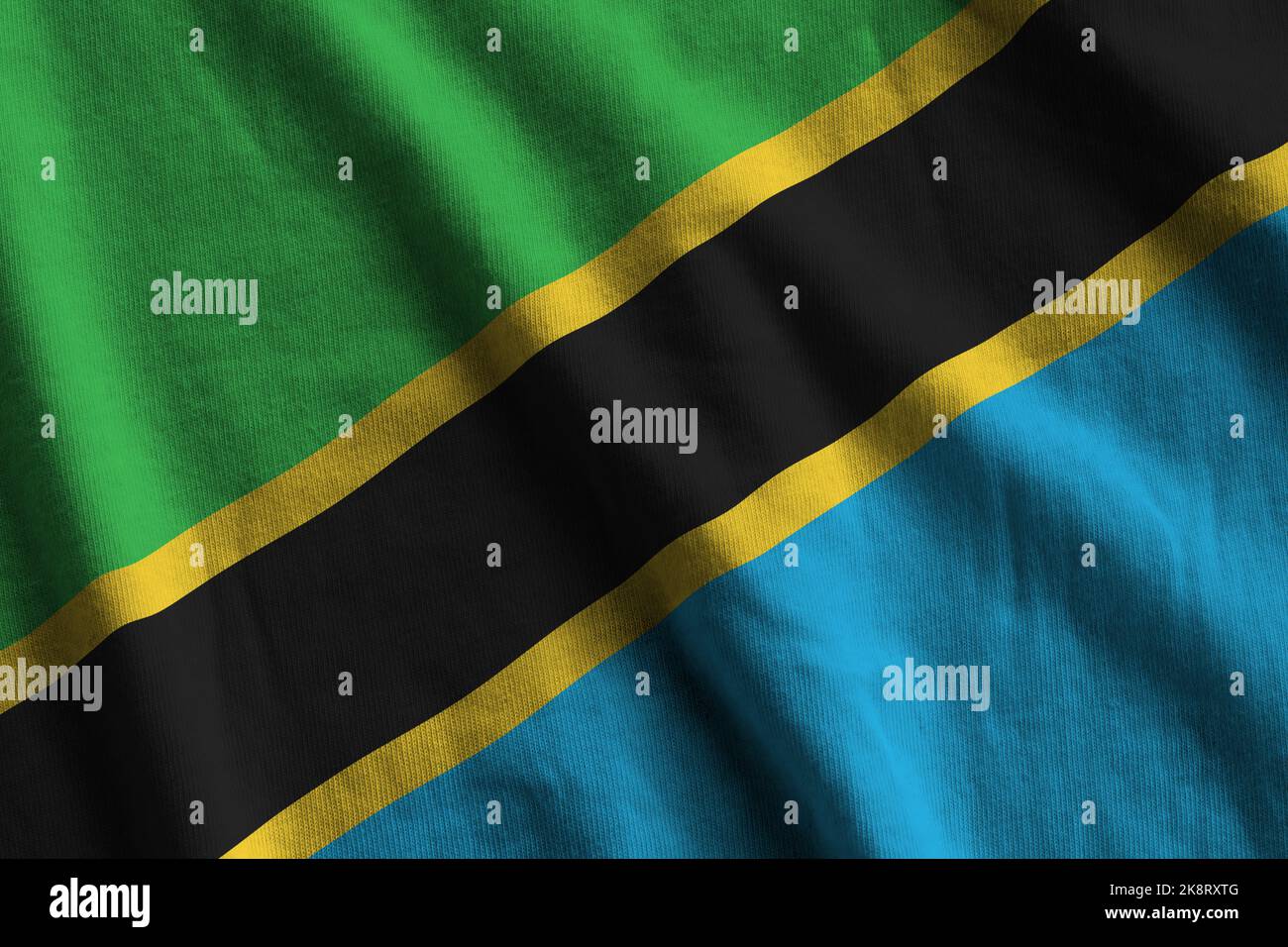 Tanzania flag with big folds waving close up under the studio light ...
