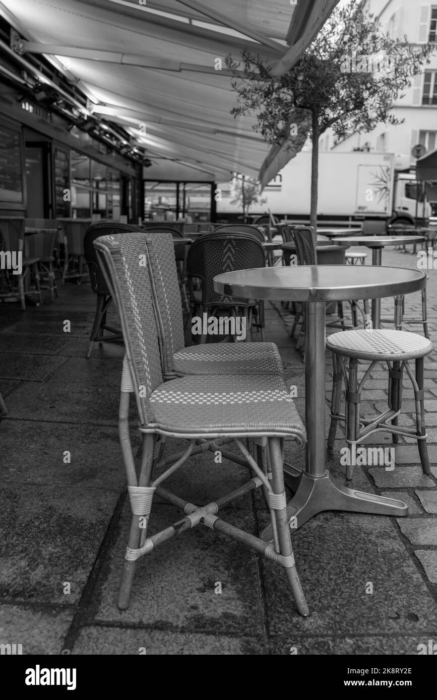 A vertical closeup grayscale of Cafe du Marche outdoors, Paris Stock ...