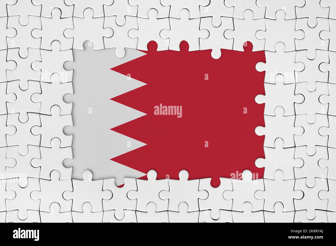 Bahrain flag in frame of white puzzle pieces with missing central parts ...