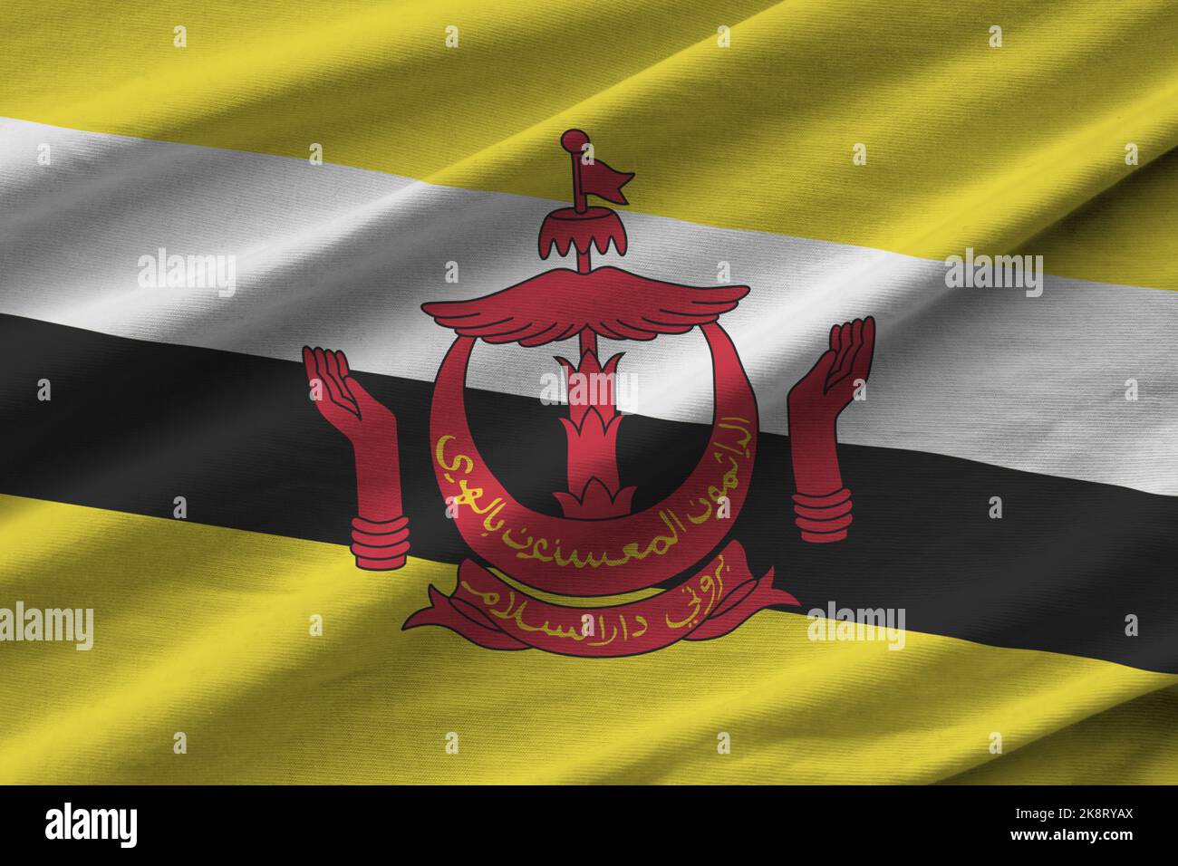 Brunei Darussalam flag with big folds waving close up under the studio ...