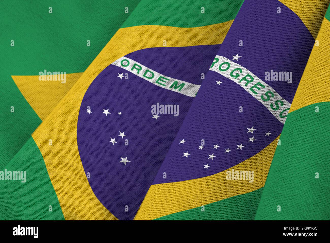 Brazil flag with big folds waving close up under the studio light ...