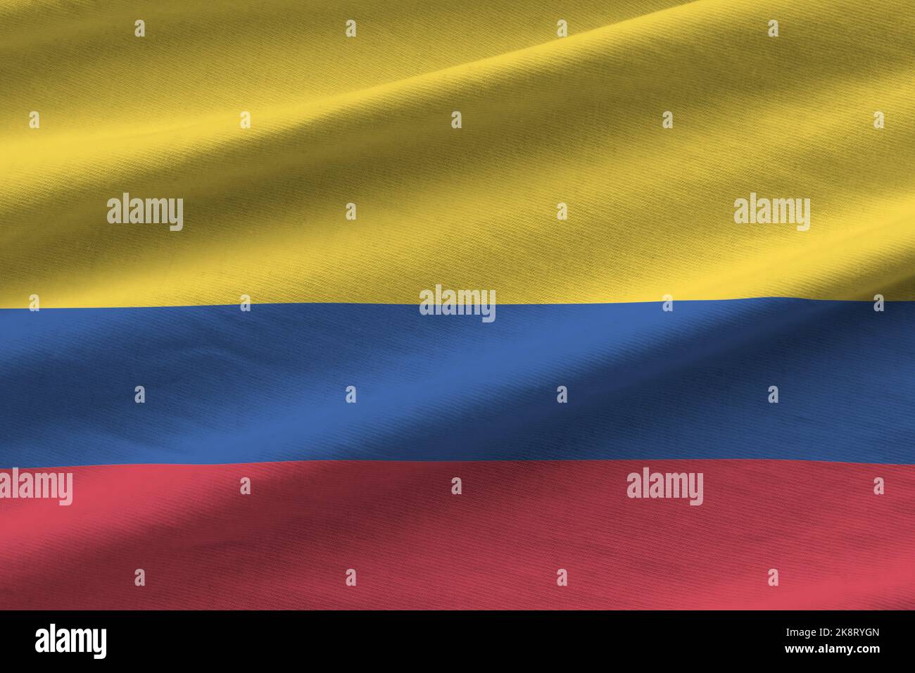 Colombia flag with big folds waving close up under the studio light ...