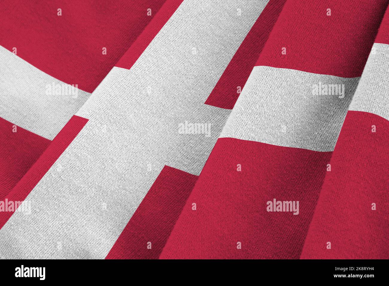 Denmark flag with big folds waving close up under the studio light ...