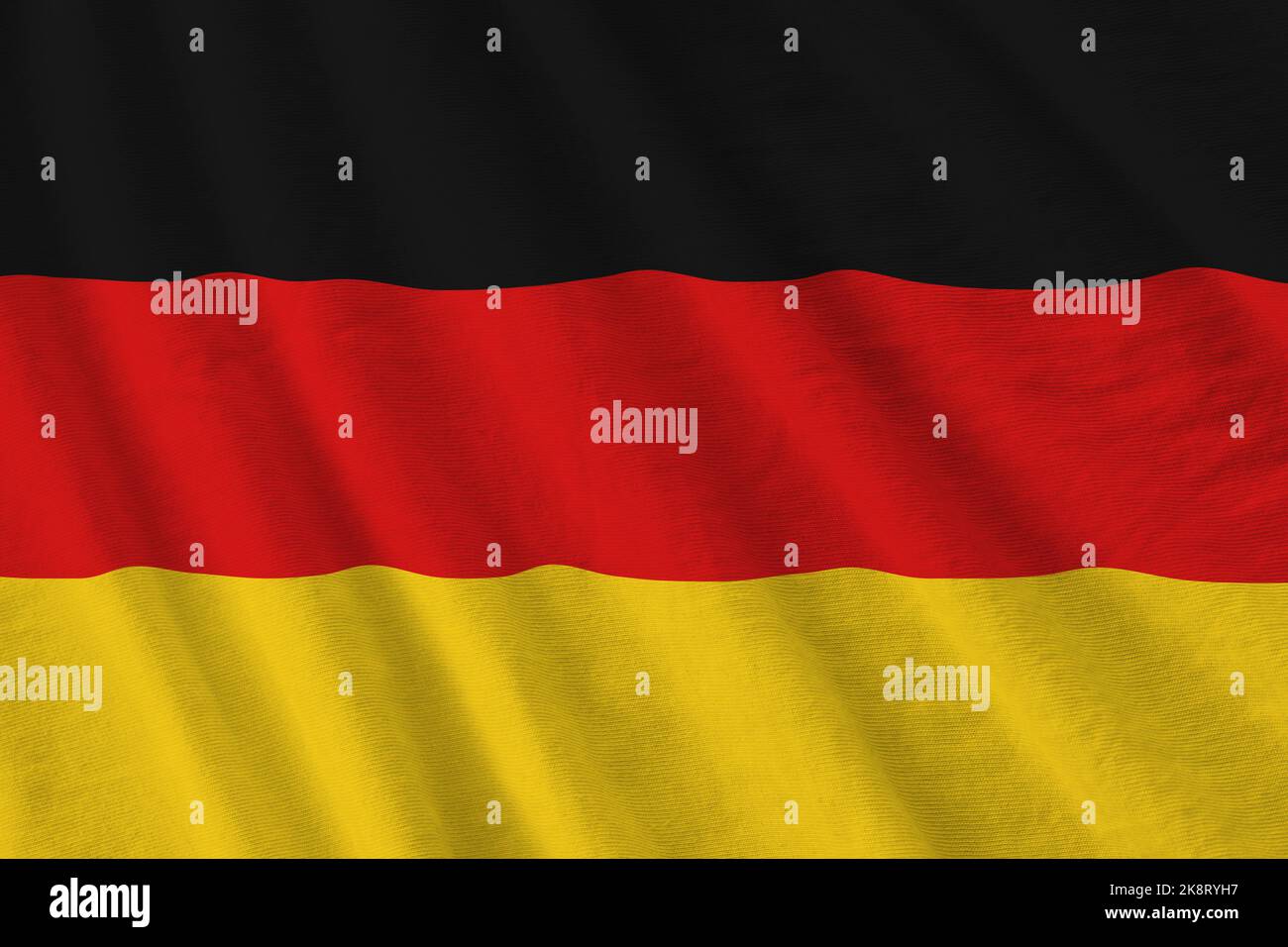 Germany flag with big folds waving close up under the studio light ...