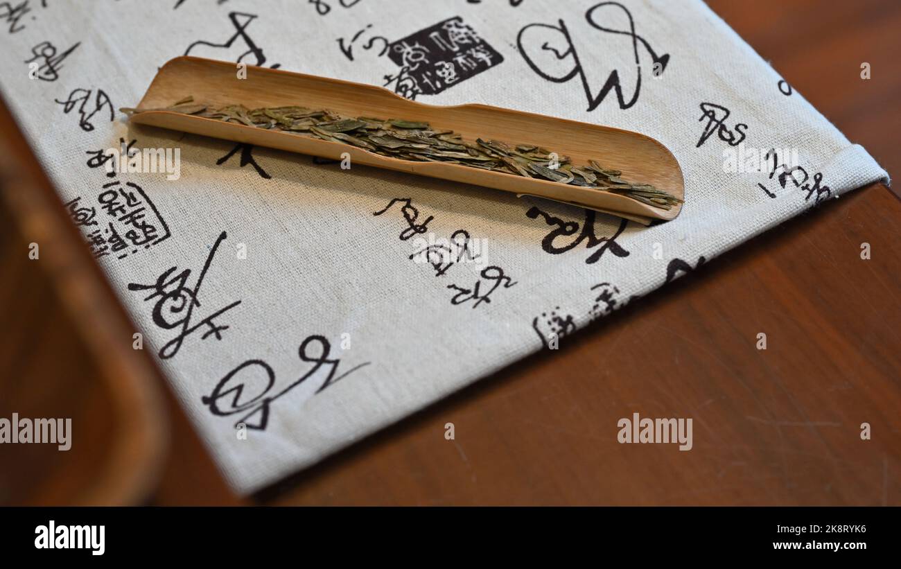 a top view of dried mocha leaves on white clothing with hieroglyph ...