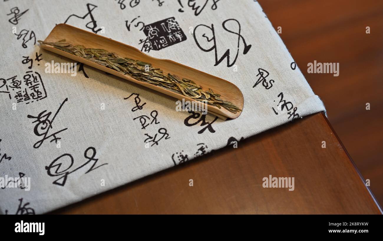 a top view of dried mocha leaves on white clothing with hieroglyph ...