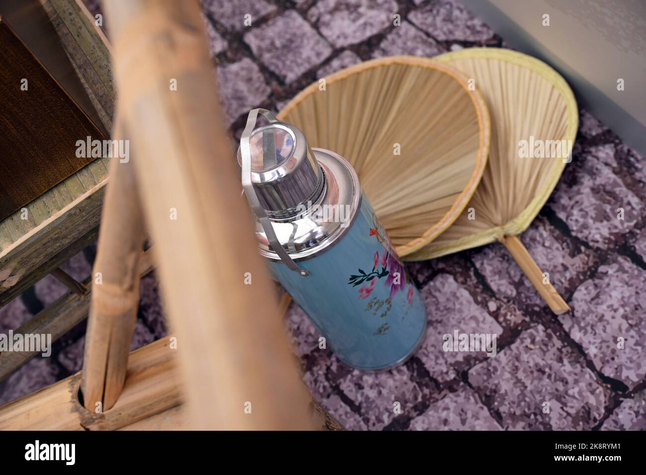 a top view of blue thermos bottle on the stone ground next to wooden ...