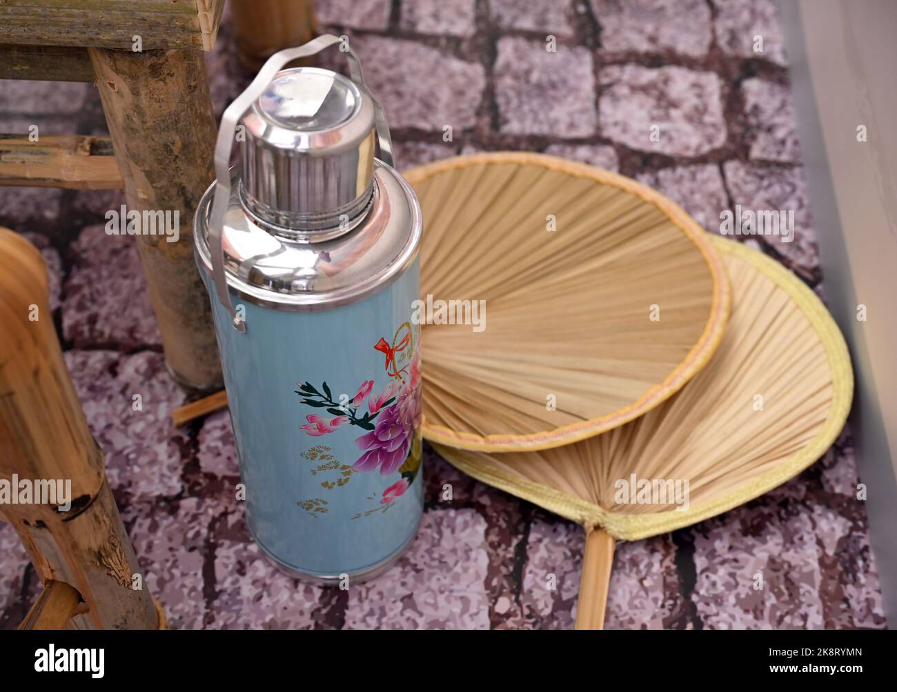 a top view of blue thermos bottle on the stone ground next to wooden ...
