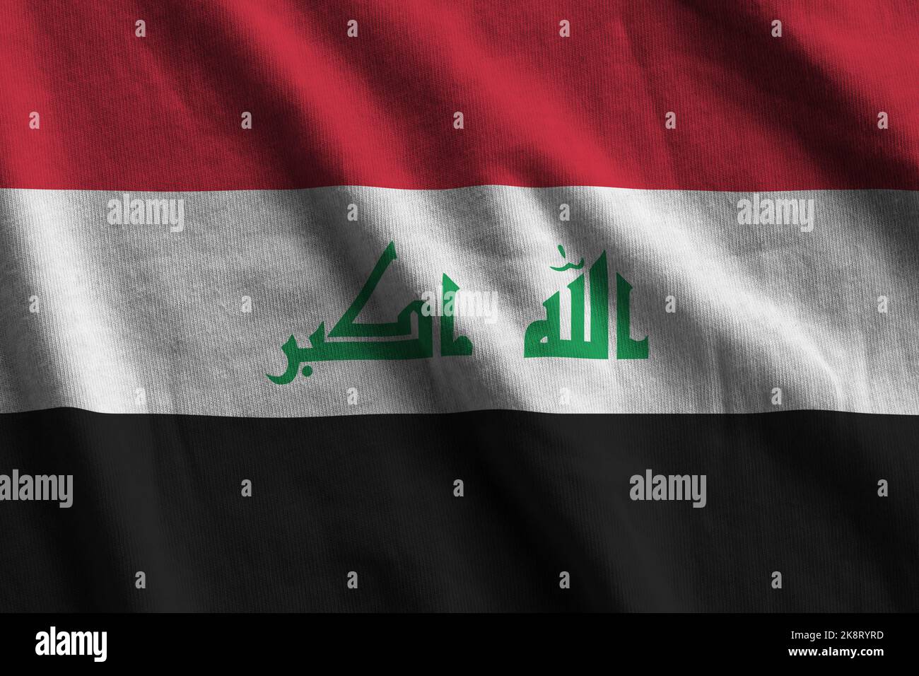Iraq flag with big folds waving close up under the studio light indoors ...