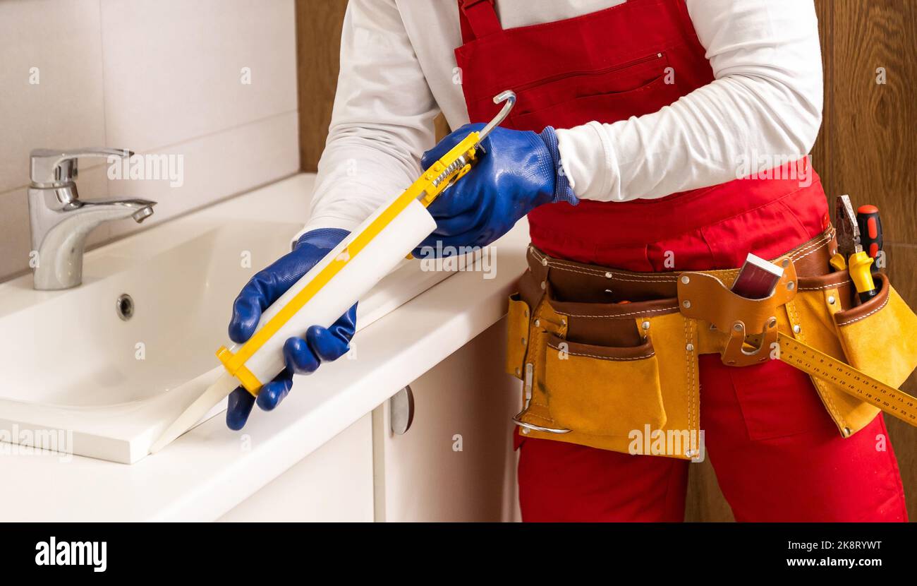 men fixing a sink in bathroom Stock Photo - Alamy