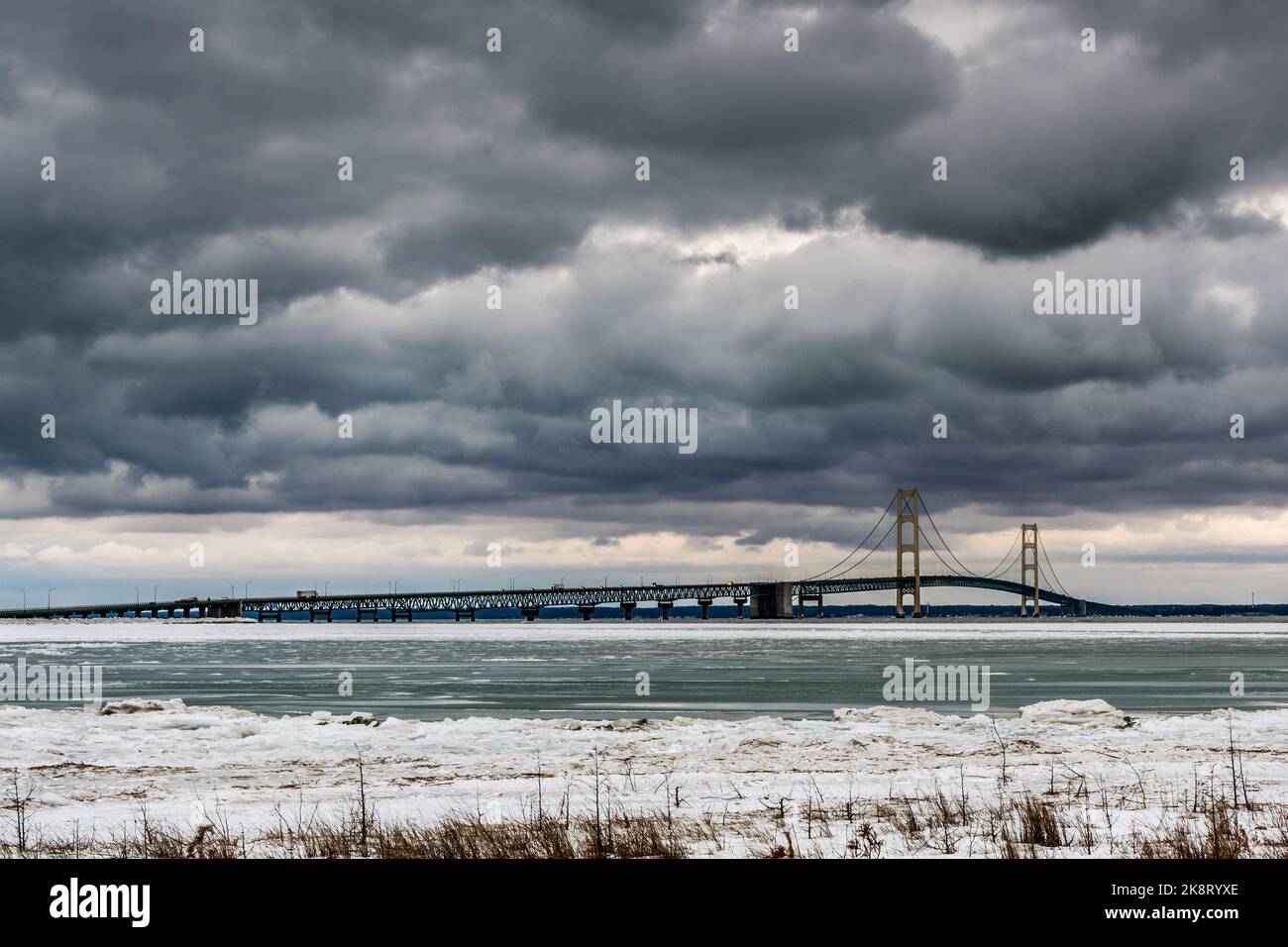 A landscape shot of the Mackinac Bridge under the dramatic cloudy sky ...