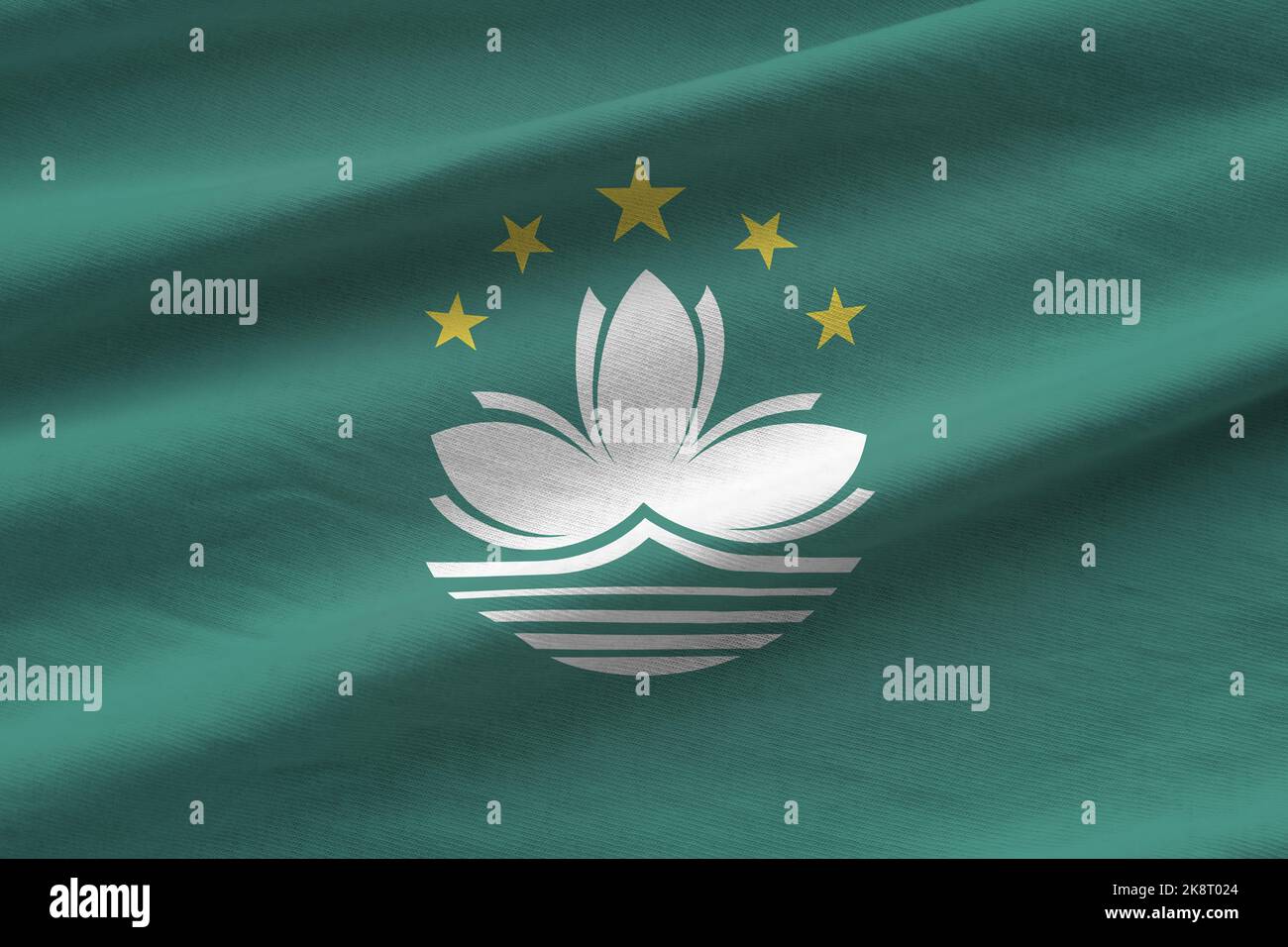 Macau flag with big folds waving close up under the studio light ...