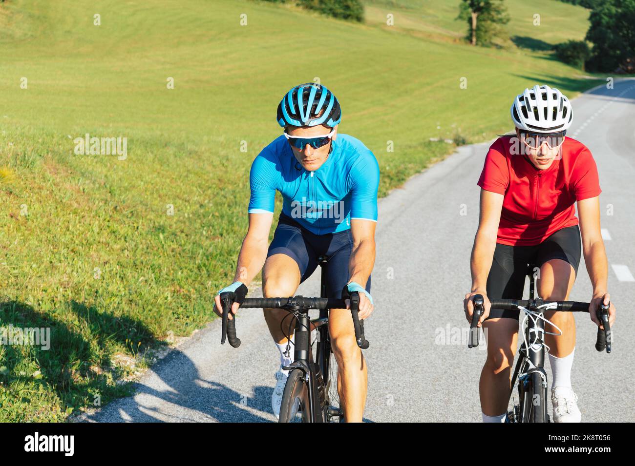 Two professional cyclist racers, male and female during training on a ...