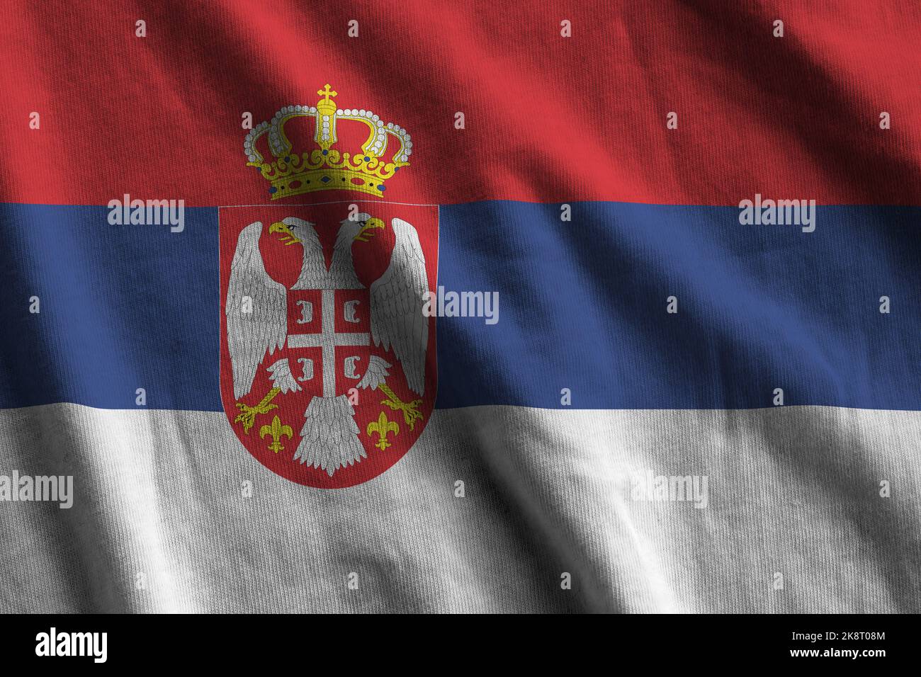 Serbia flag with big folds waving close up under the studio light ...