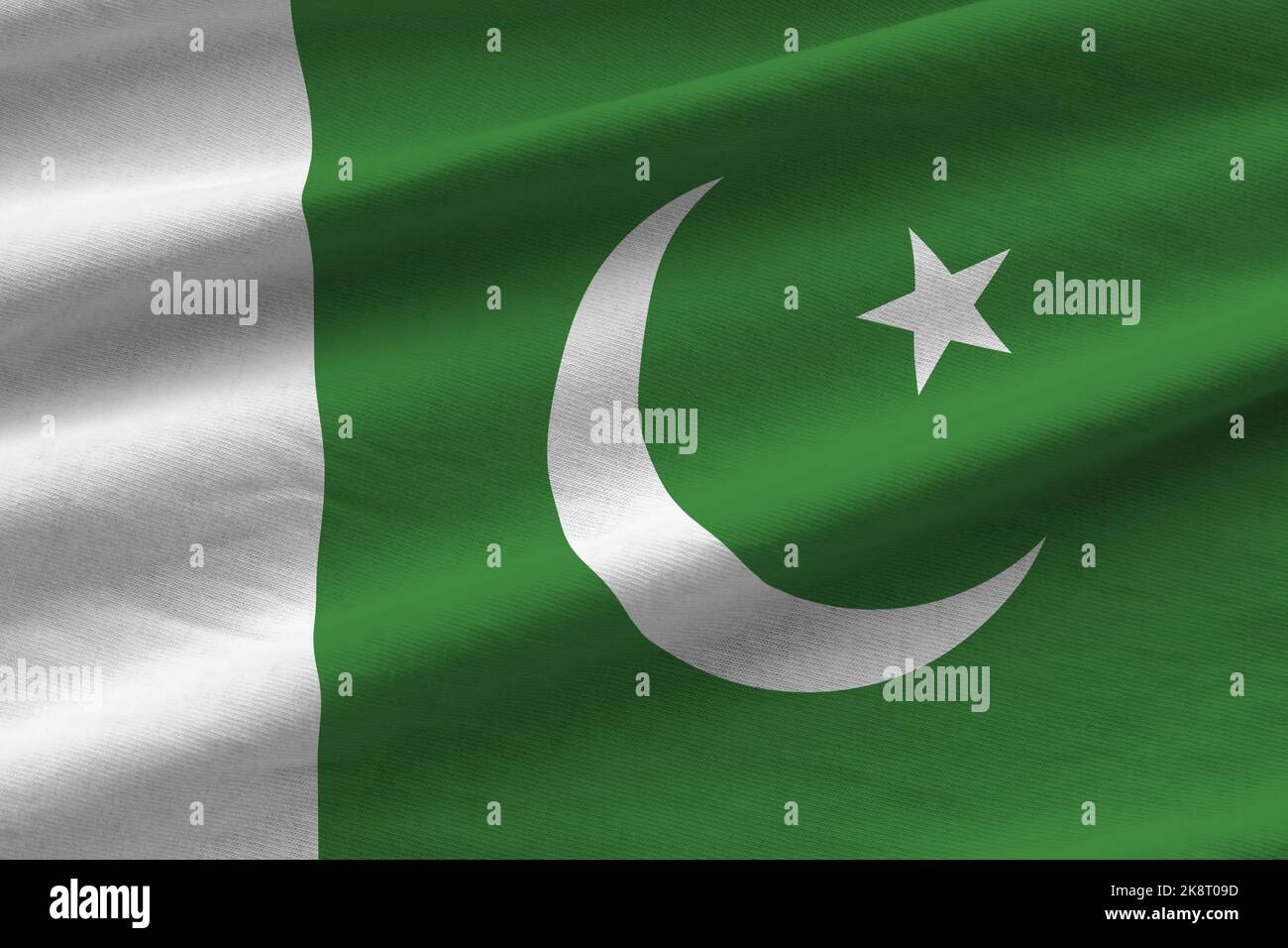 Pakistan flag with big folds waving close up under the studio light ...