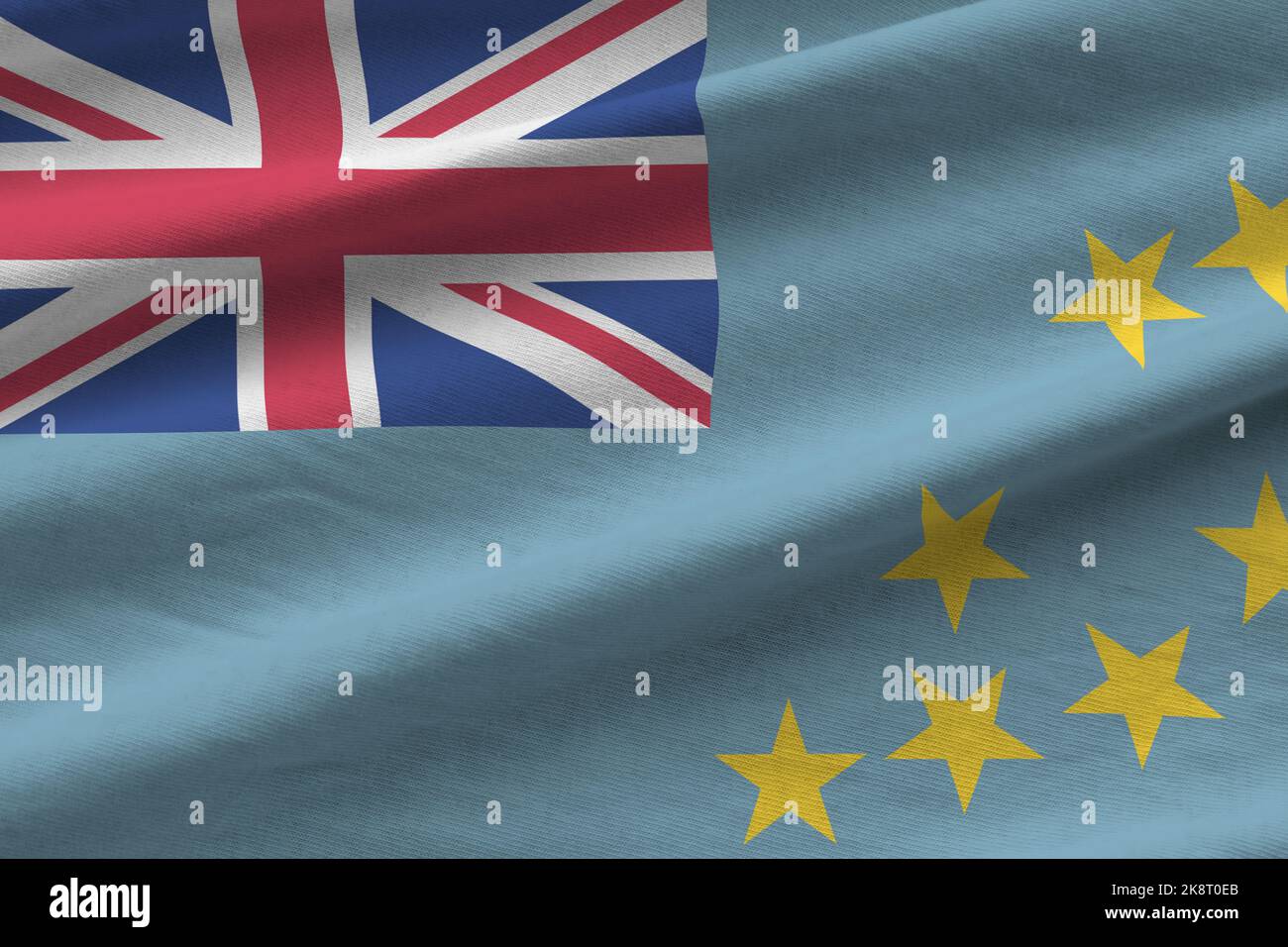Tuvalu flag with big folds waving close up under the studio light ...