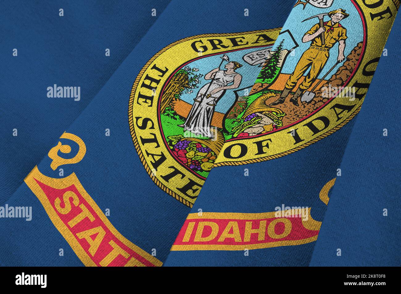 Idaho US state flag with big folds waving close up under the studio ...