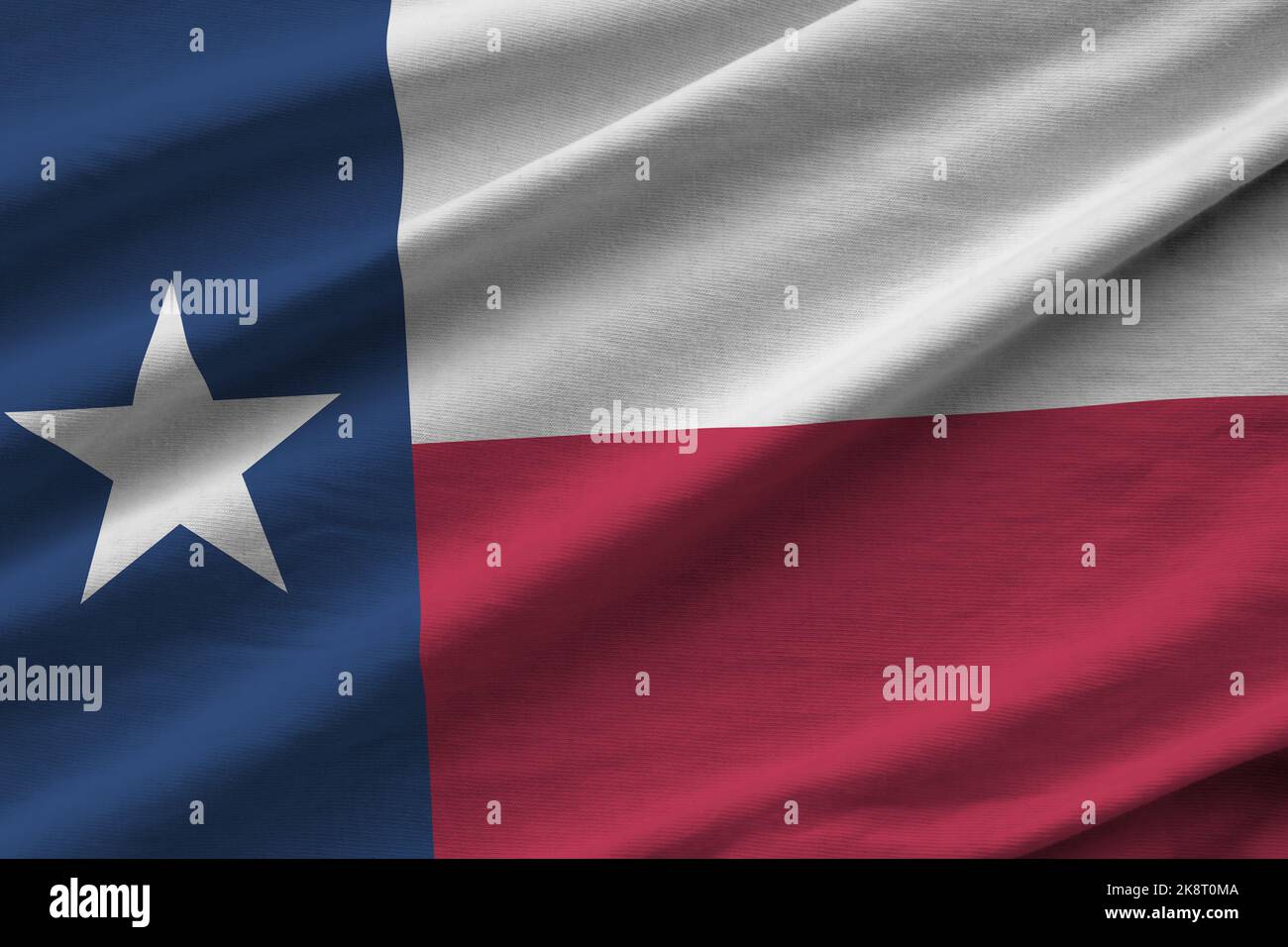 Texas US state flag with big folds waving close up under the studio ...