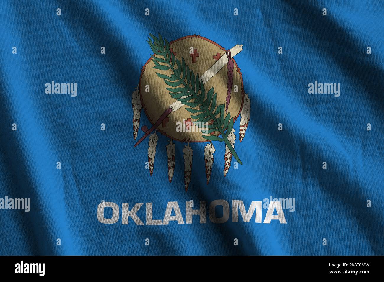 Oklahoma US state flag with big folds waving close up under the studio ...