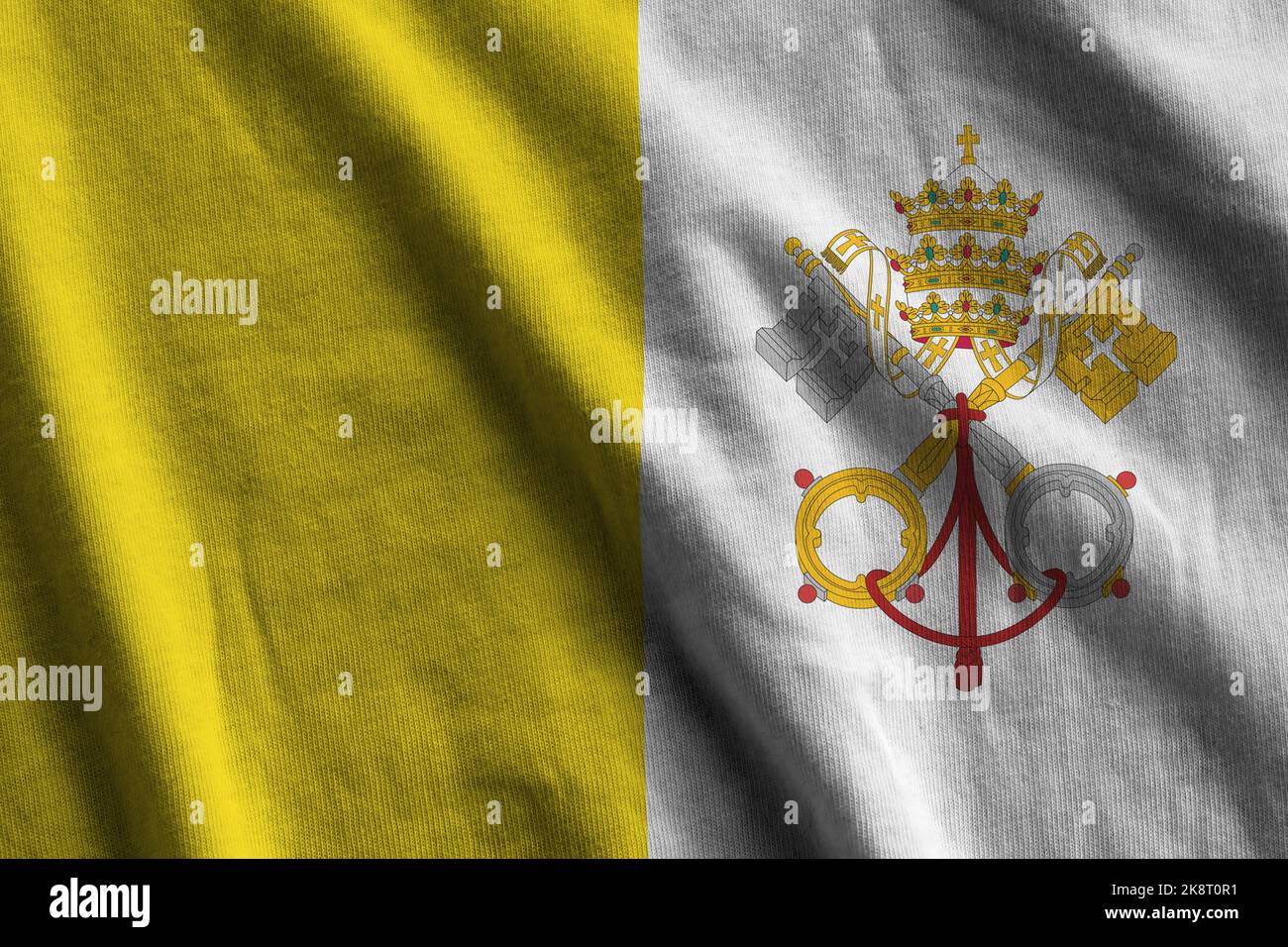 Vatican City State flag with big folds waving close up under the studio ...