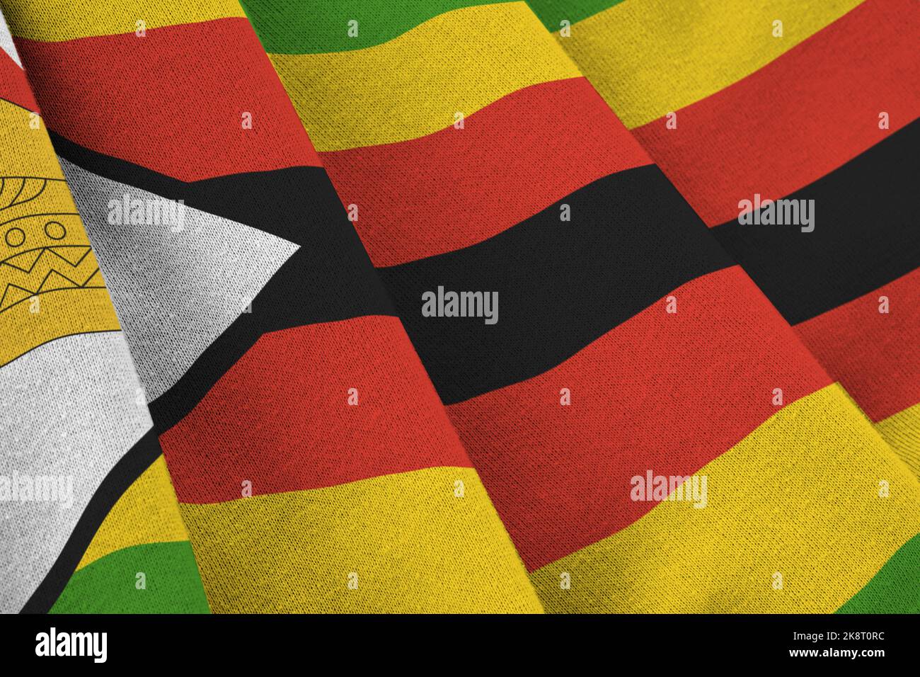 Zimbabwe flag with big folds waving close up under the studio light ...