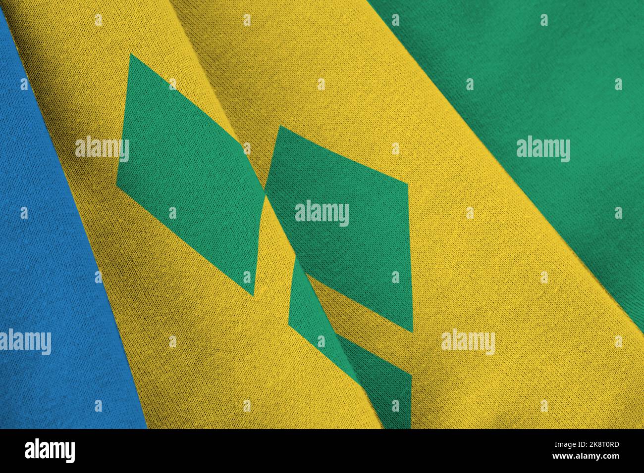 Saint Vincent and the Grenadines flag with big folds waving close up ...
