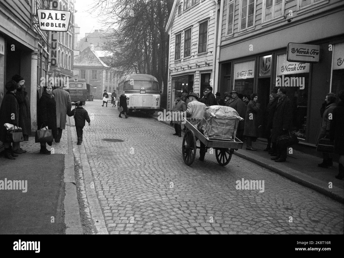Bergen November 19, 1965. The cityscape from Bergen. A man draws a cart ...