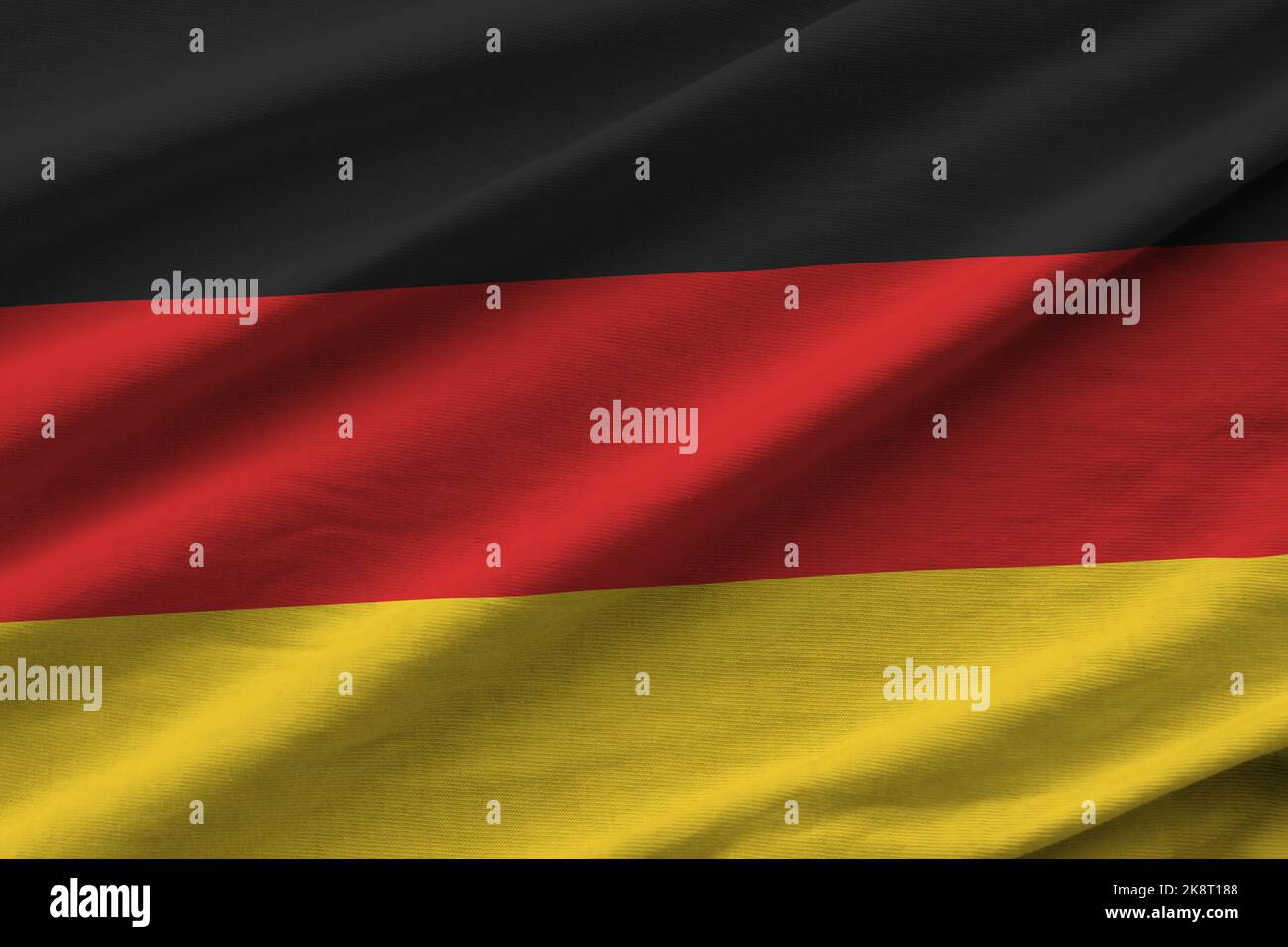 Germany flag with big folds waving close up under the studio light ...