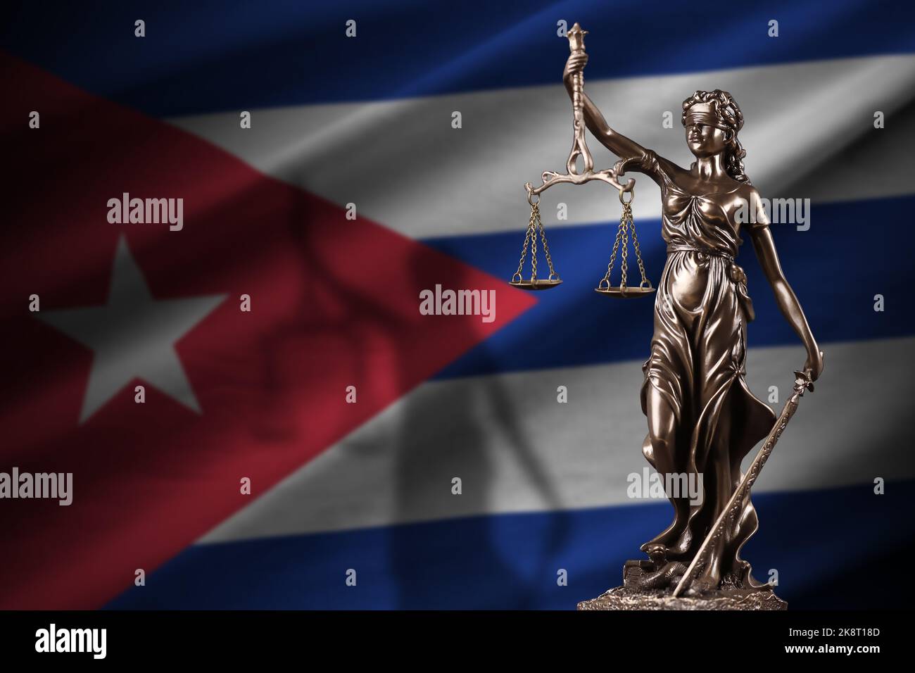 Cuba flag with statue of lady justice and judicial scales in dark room ...