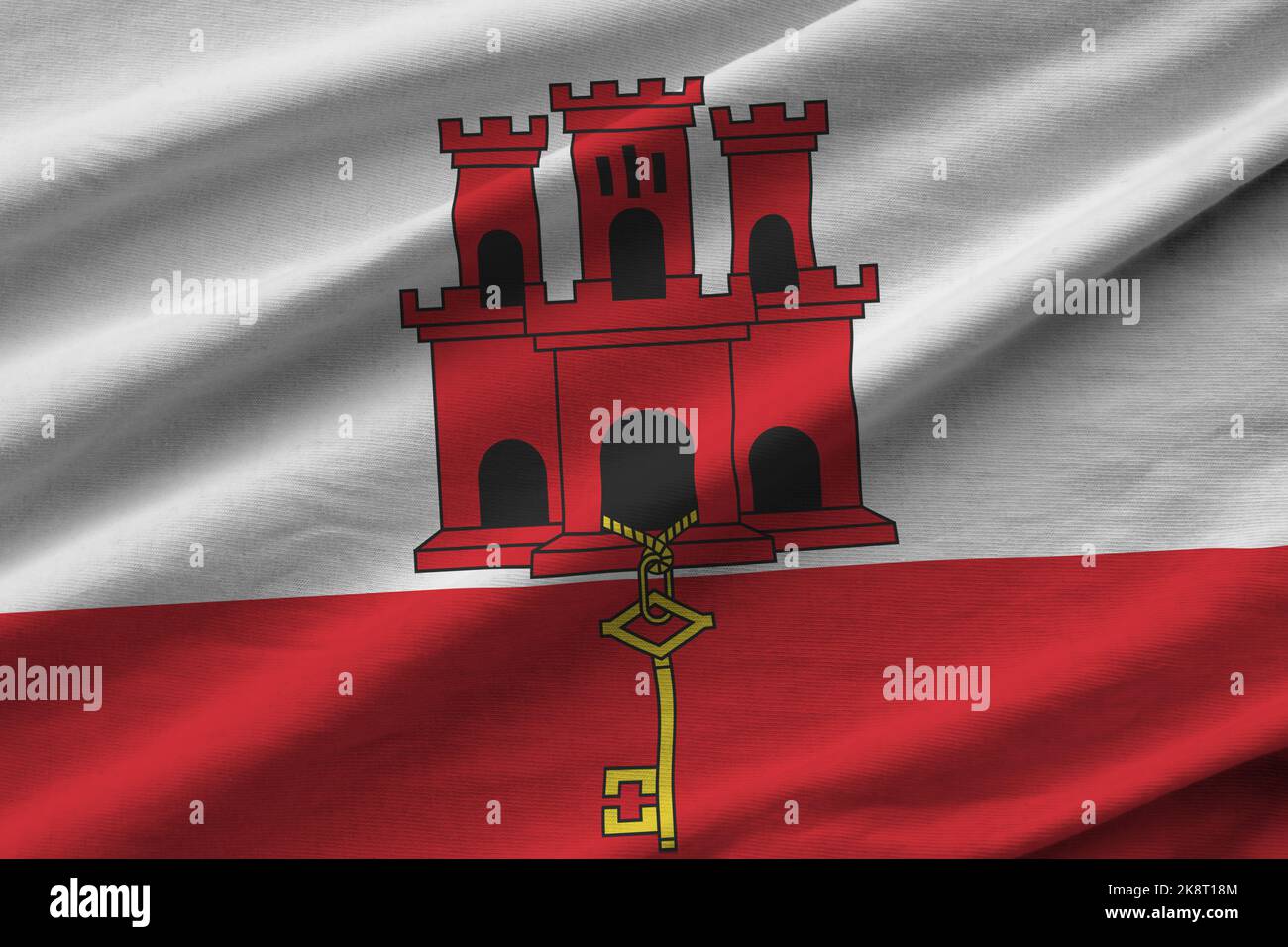 Giblartar flag with big folds waving close up under the studio light ...