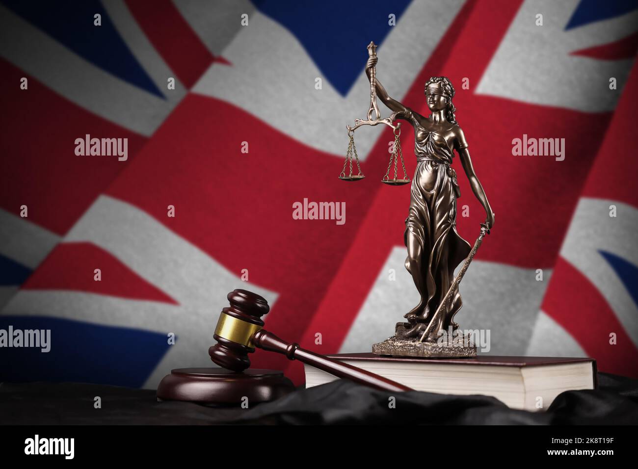 Great britain flag with statue of lady justice, constitution and judge ...