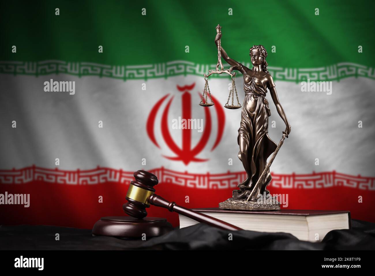 Iran flag with statue of lady justice, constitution and judge hammer on ...