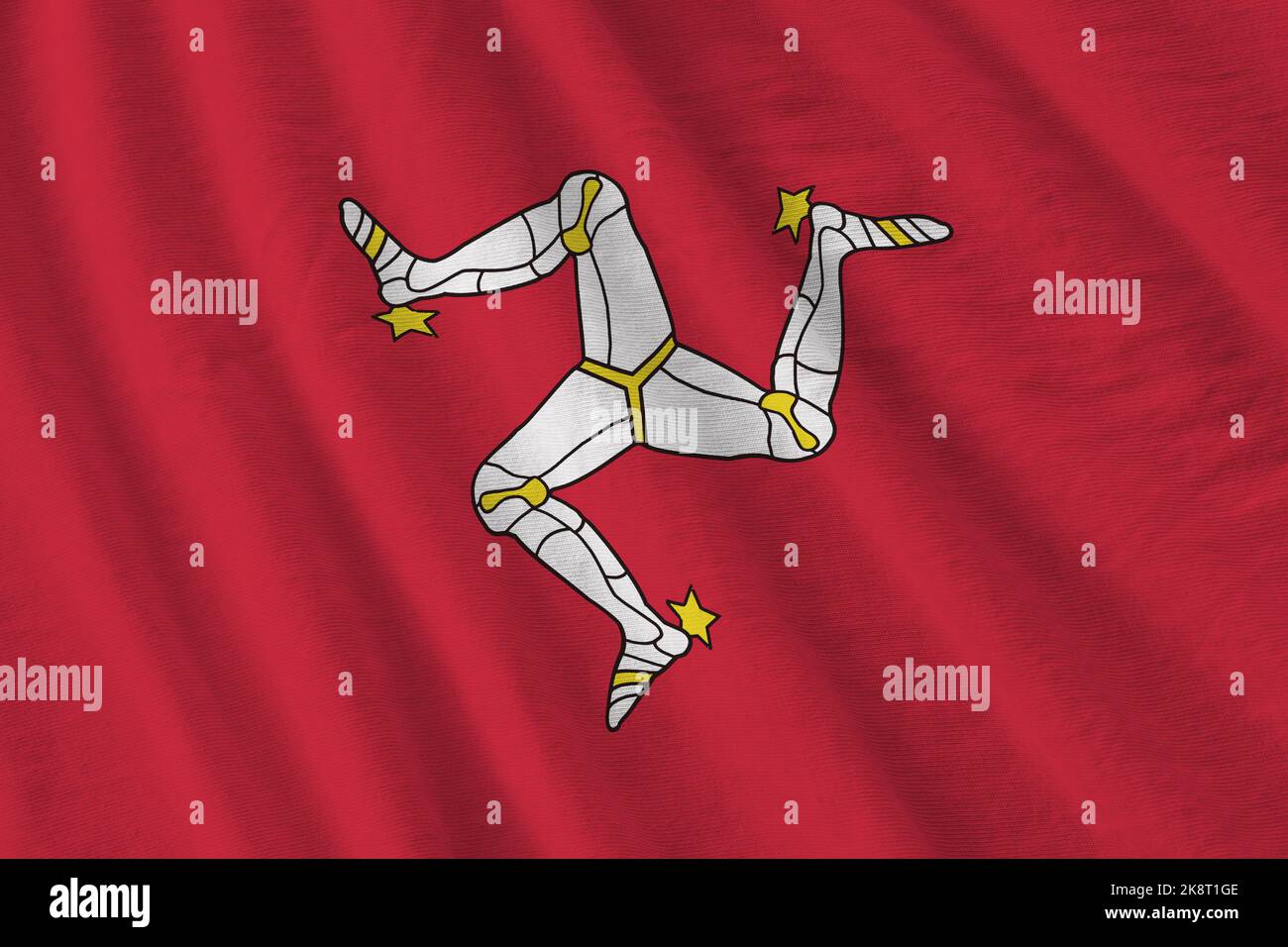 Isle of Man flag with big folds waving close up under the studio light ...